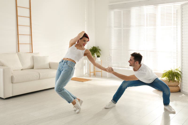 Beautiful Young Couple Dancing in Living Room Stock Image - Image of ...