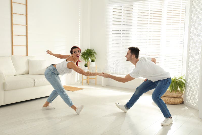 Beautiful Young Couple Dancing in Living Room Stock Photo - Image of ...