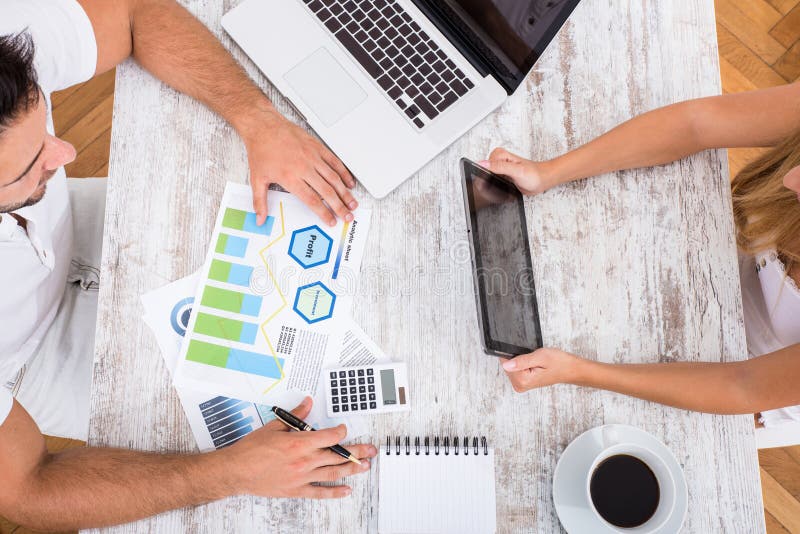 A Beautiful Young Couple Discuss Business Stock Photo - Image of paper ...