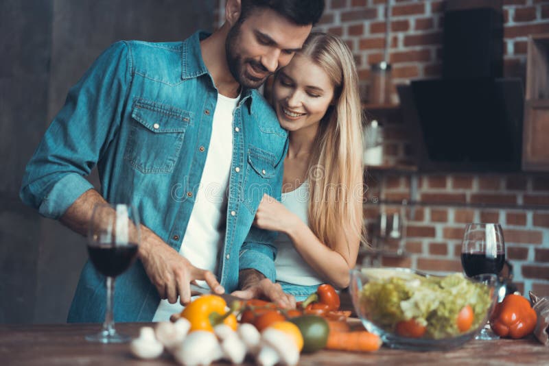 Beautiful Young Couple Preparing A Healthy Meal Together While Spending