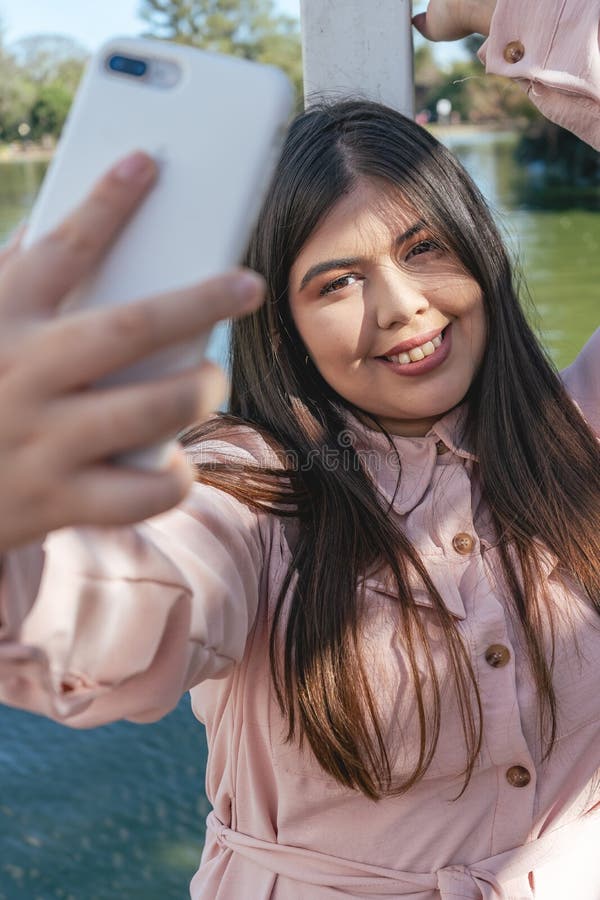 Beautiful Young Curvy Girl Taking A Selfie While Smiling Happily Outdoors Stock Image Image Of