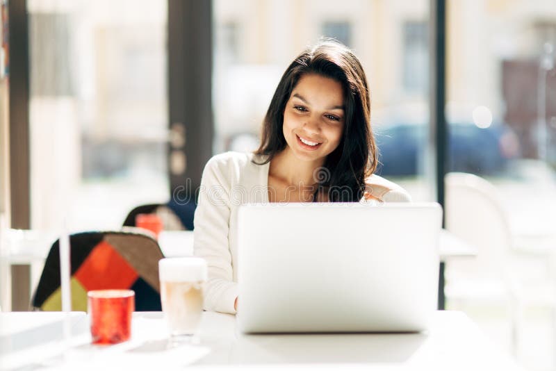 Brunette Using Laptop in Cafe Stock Photo - Image of beautiful, adult ...