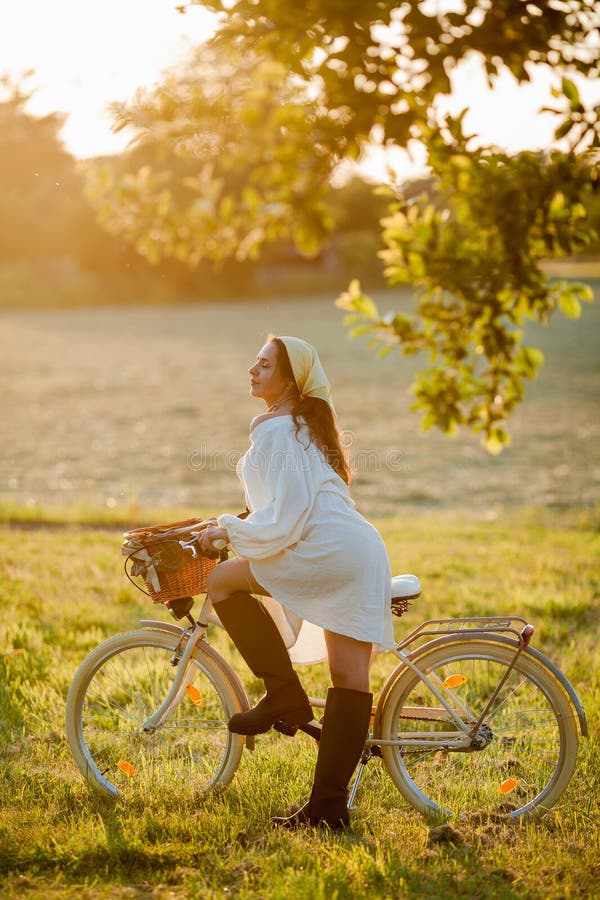 Beautiful Young Dark Haired Woman On Picnic In Field Model In Stylish Clothes With Bicycle