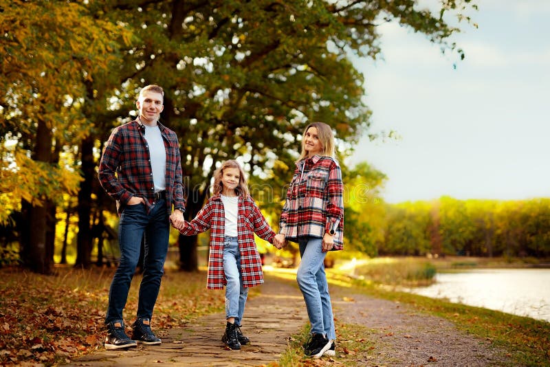 Beautiful Young Family on a Walk in Autumn Forest Stock Photo - Image ...