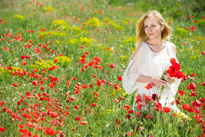 Beautiful Young Female In White Dress Holding Bouquet Of Poppy Flowers