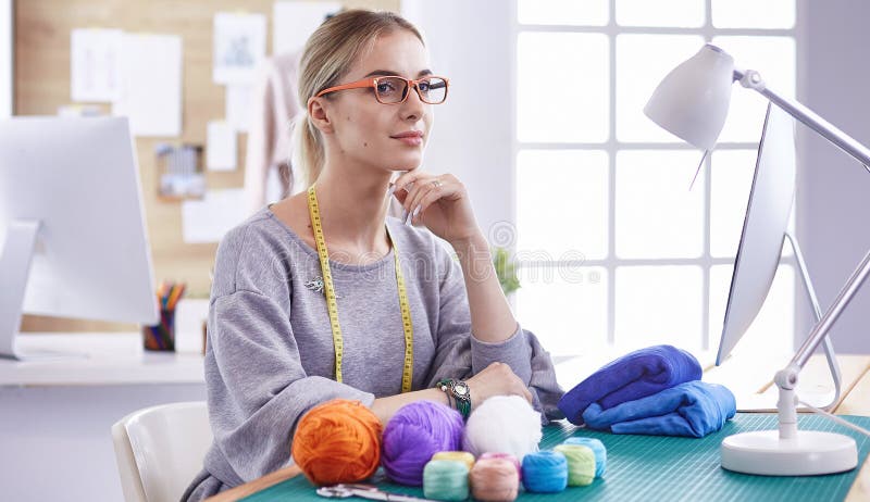 Beautiful Young Girl in a Factory with a Sewing Machine at the Table ...