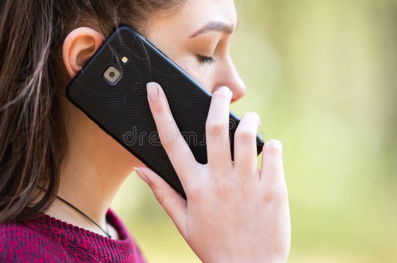 Beautiful Young Girl in the Nature Using Her Mobile Phone Stock Photo ...