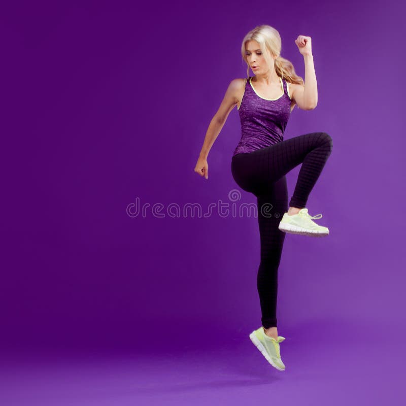 Beautiful Young Girl in a Pose Runner. Studio Background, Purple. Happy ...