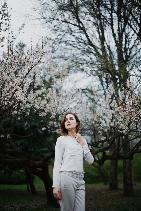 Beautiful Young Girl is Resting and Enjoying Spring in the Spring Park ...