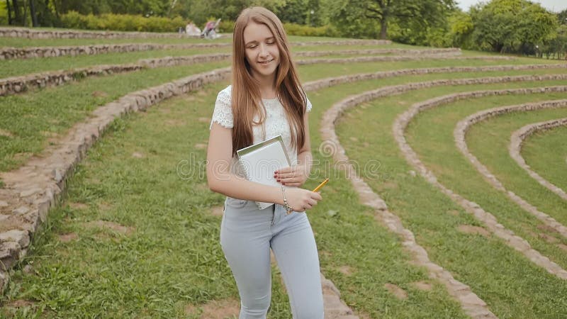 Beautiful Young Girl Student with Textbooks and Notes Smiling Strolling ...