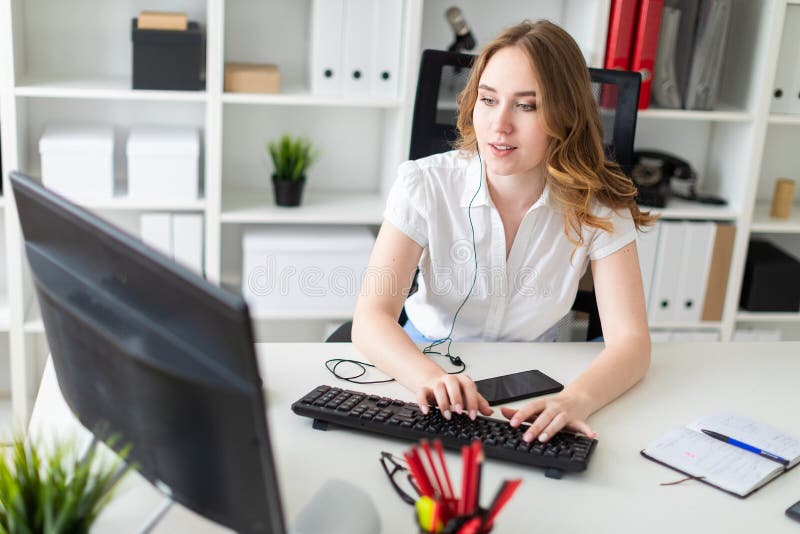 Beautiful Young Girl Working with Computer in Office. the Girl Has an ...