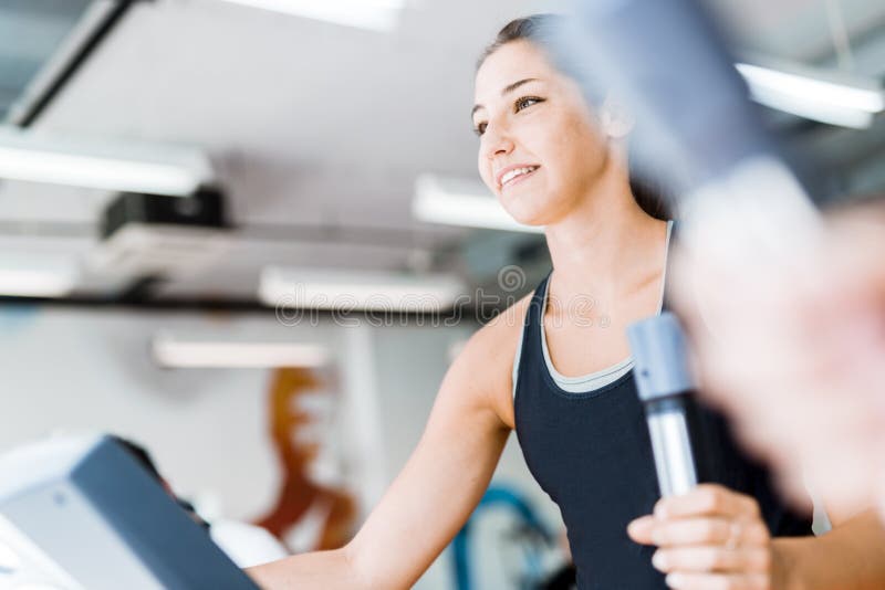 Beautiful Young Lady Using the Elliptical Trainer Stock Image - Image ...