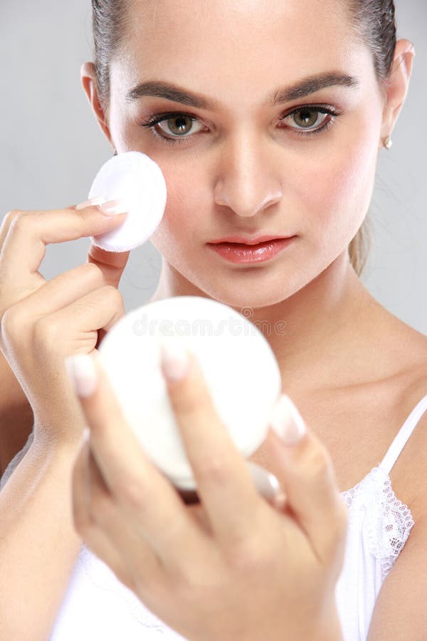 Beautiful Young Model Holding a Compact Powder and Applying Some Stock ...
