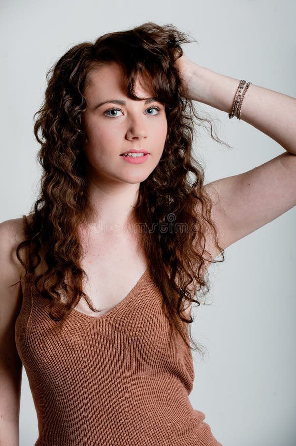 Beautiful Young Model with Long Curly Hair Posing in a Studio Stock ...