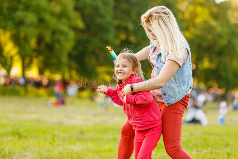 Beautiful Young Mother And Her Daughter Having Fun At The Field Stock