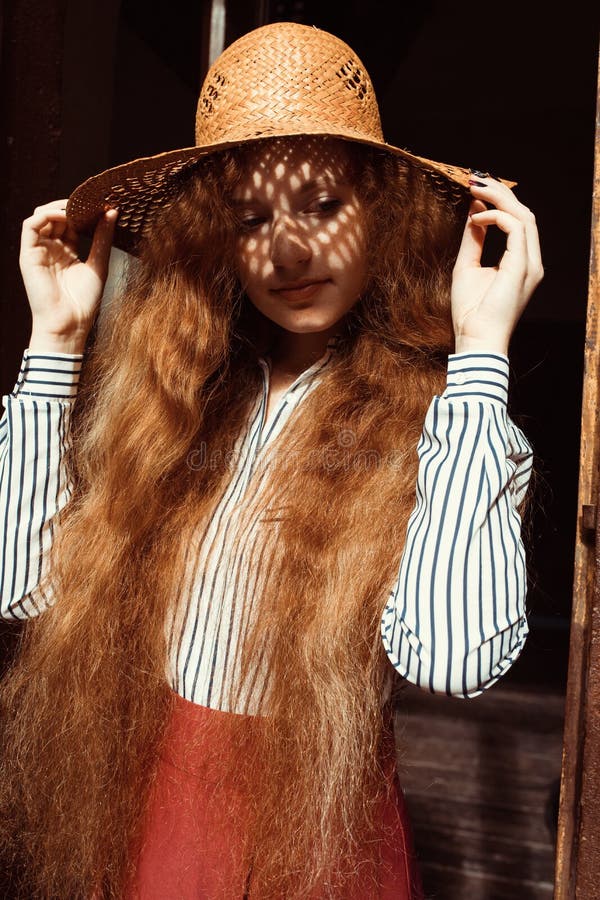 Beautiful Young Red Haired Model With Long Curly Hair In Straw H Stock