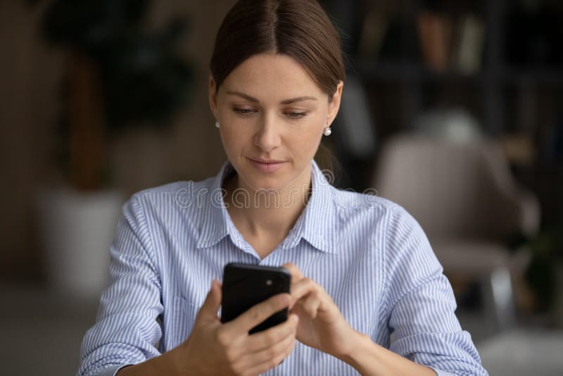 Beautiful Young 30s Woman Using Smartphone Apps at Workplace. Stock ...