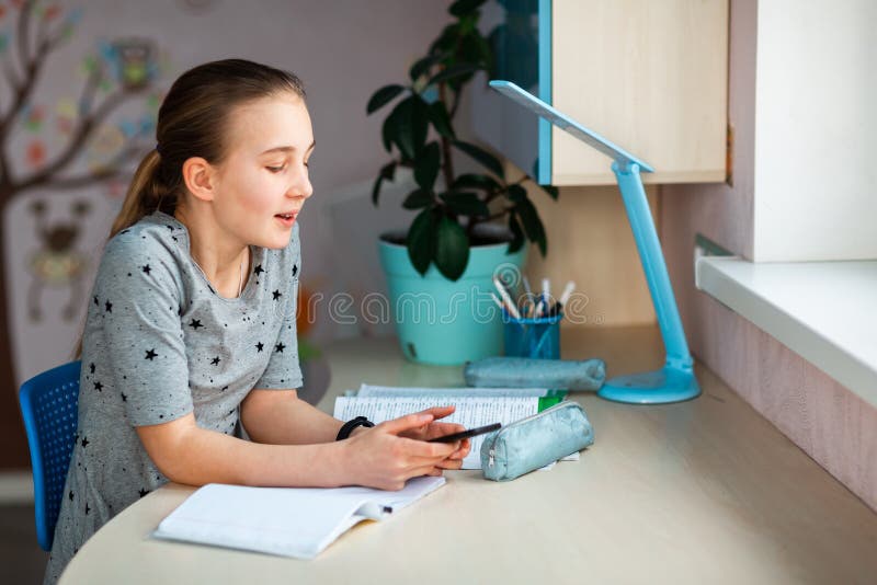 Beautiful Young School Girl Working at Home with Class Notes Checking ...