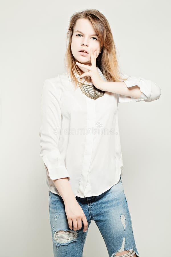 Beautiful Young Woman in Blue Jeans Posing Stock Photo - Image of ...