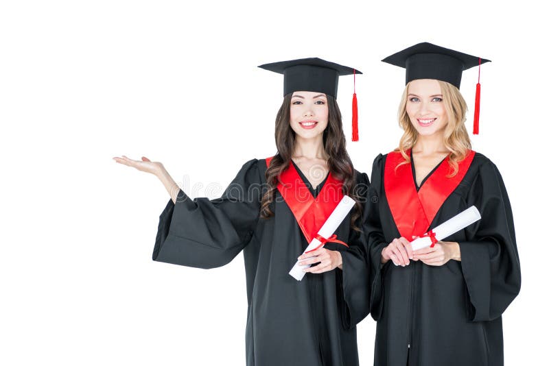 Beautiful Young Students in Academic Caps Holding Diplomas and Smiling ...