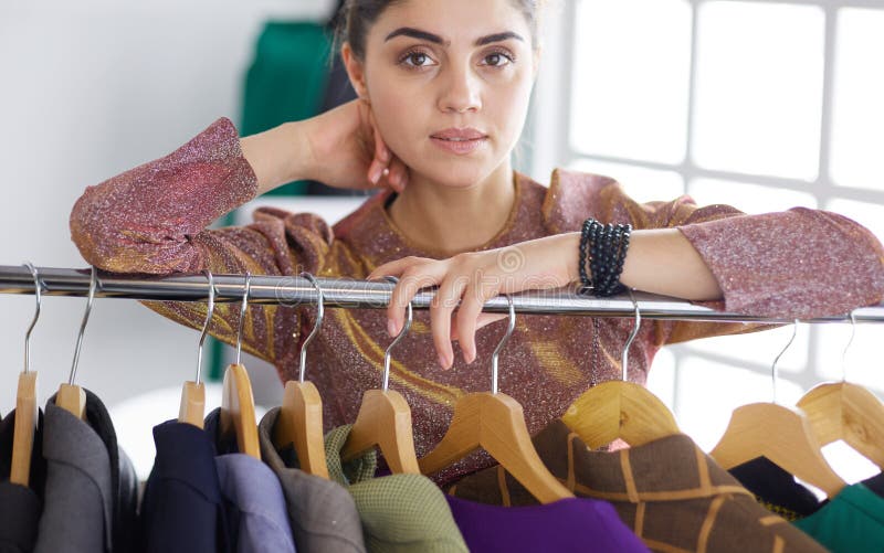 Beautiful Young Stylist Near Rack with Hangers Stock Image - Image of ...