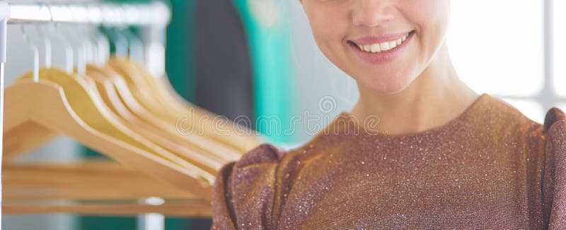 Beautiful Young Stylist Near Rack with Hangers Stock Photo - Image of ...