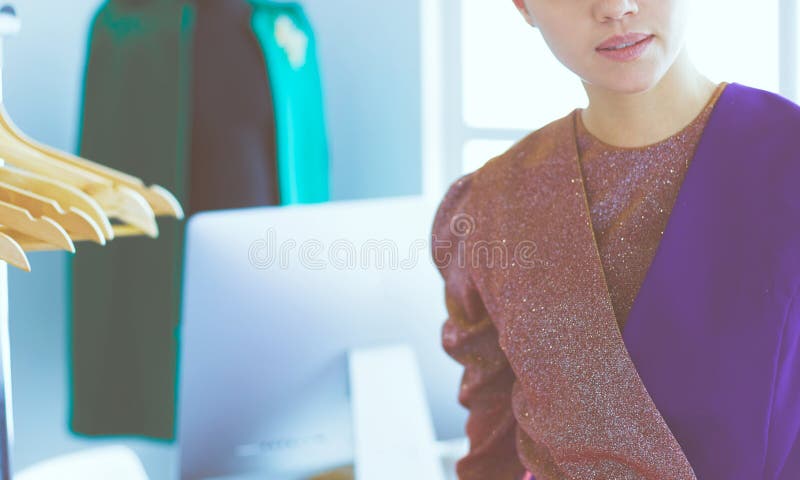 Beautiful Young Stylist Near Rack with Hangers Stock Photo - Image of ...