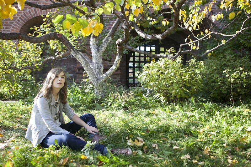 The Beautiful Young Teenager Sitting on a Trunk of a Tree Stock Image ...