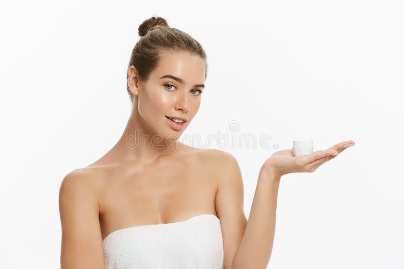 Beautiful Young Woman Applying Cosmetic Cream Treatment On Her Face