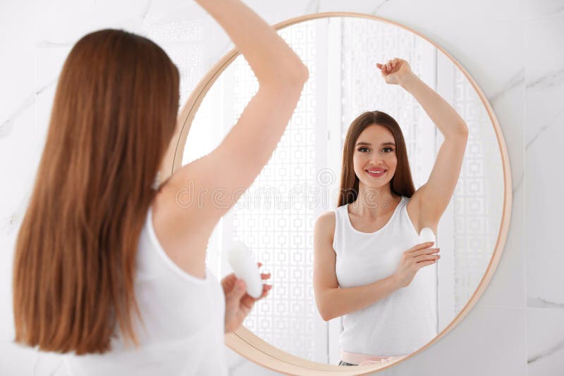 Beautiful Young Woman Applying Deodorant in Stock Image - Image of ...