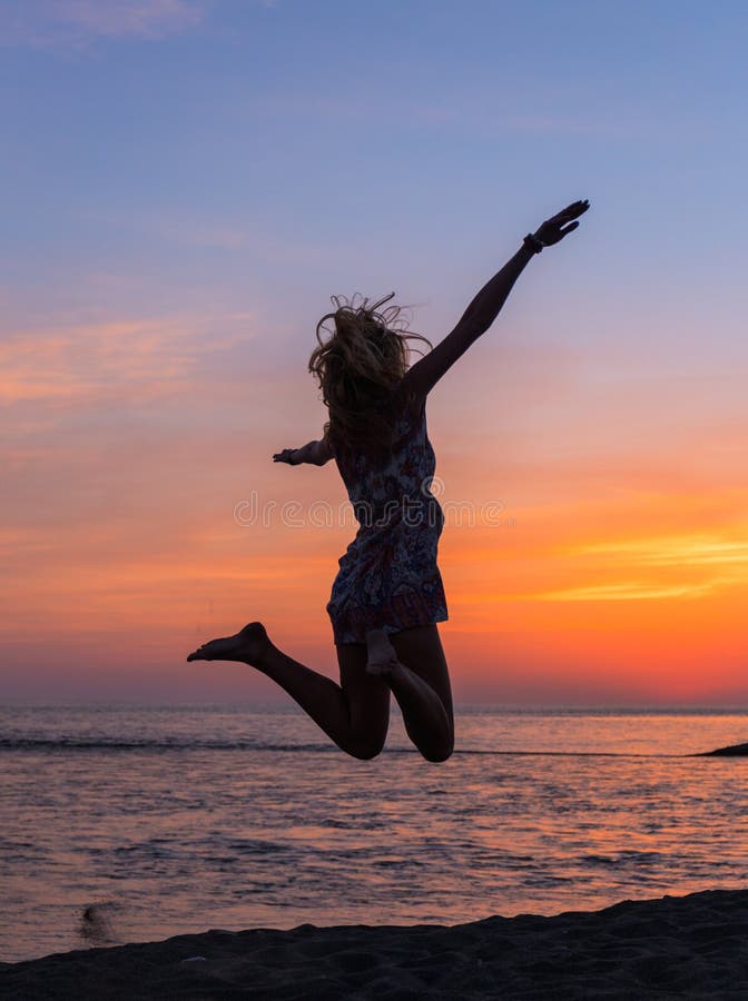 Beautiful Young Woman on the Beach at Sunset Evening Stock Photo ...