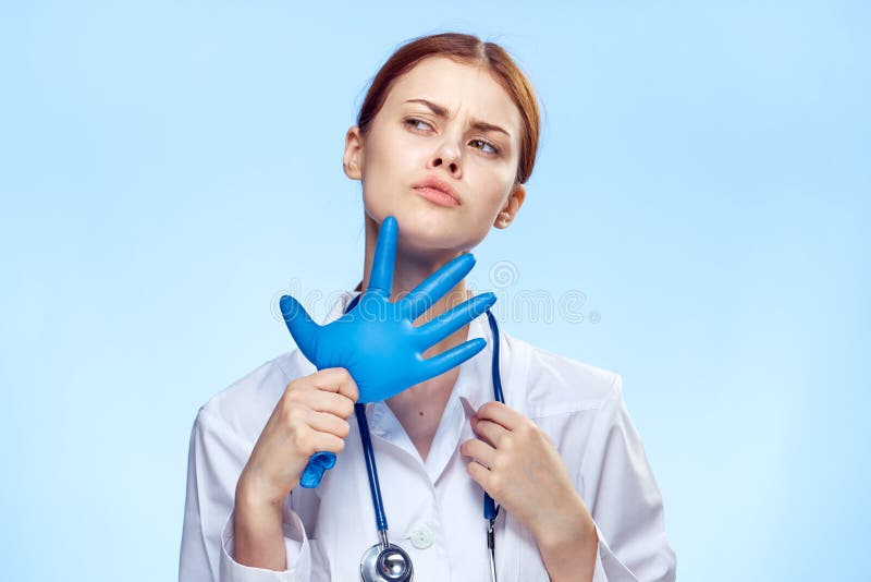 Beautiful Young Woman On A Blue Background In A Medical Dressing Gown