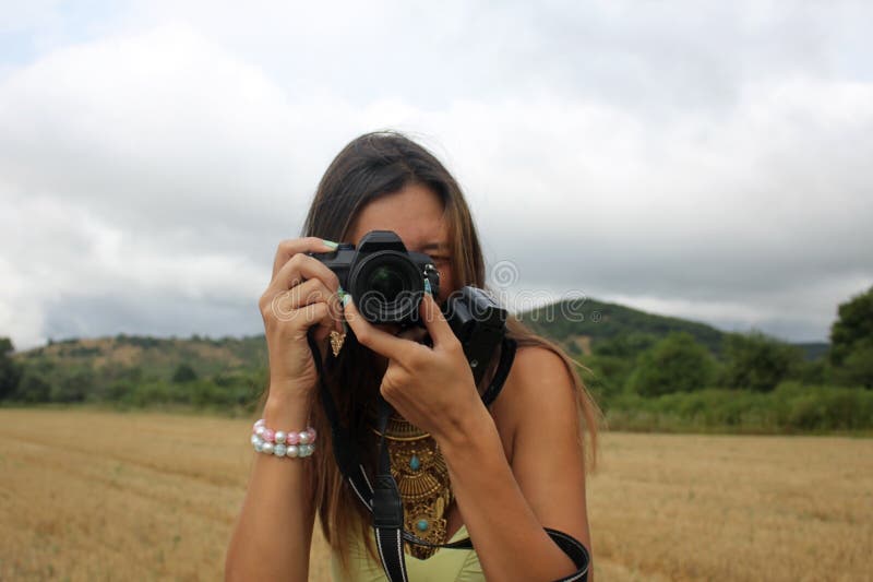A Beautiful Young Woman with a Camera Stock Photo - Image of pose ...