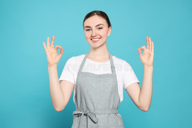 Beautiful Young Woman in Clean Apron with Pattern on Light Blue ...
