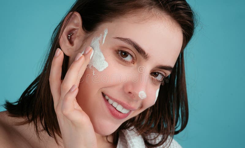Beautiful Young Woman With Clean Fresh Skin Applying Moisturizer Cream