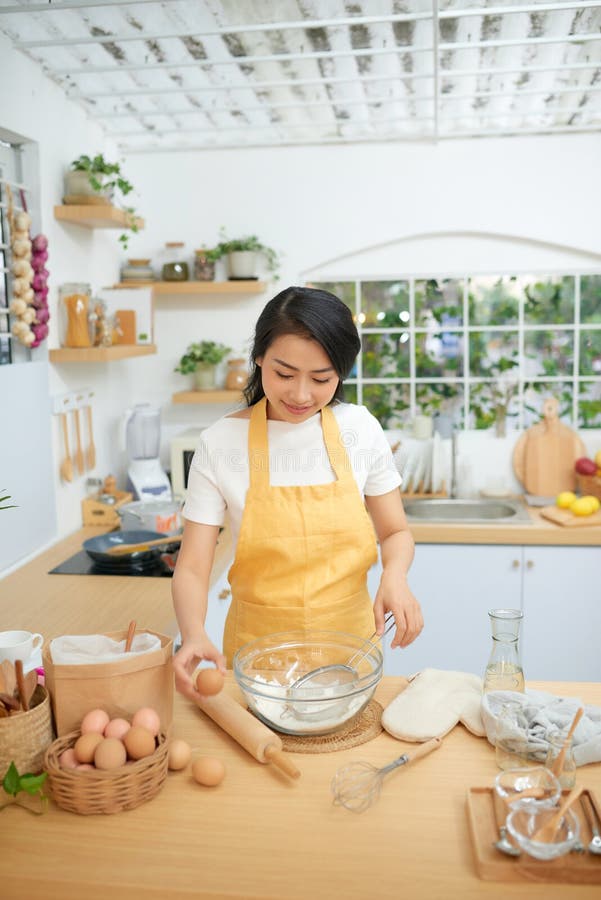 Beautiful Young Woman Cooking Pastry in Kitchen Stock Photo - Image of ...