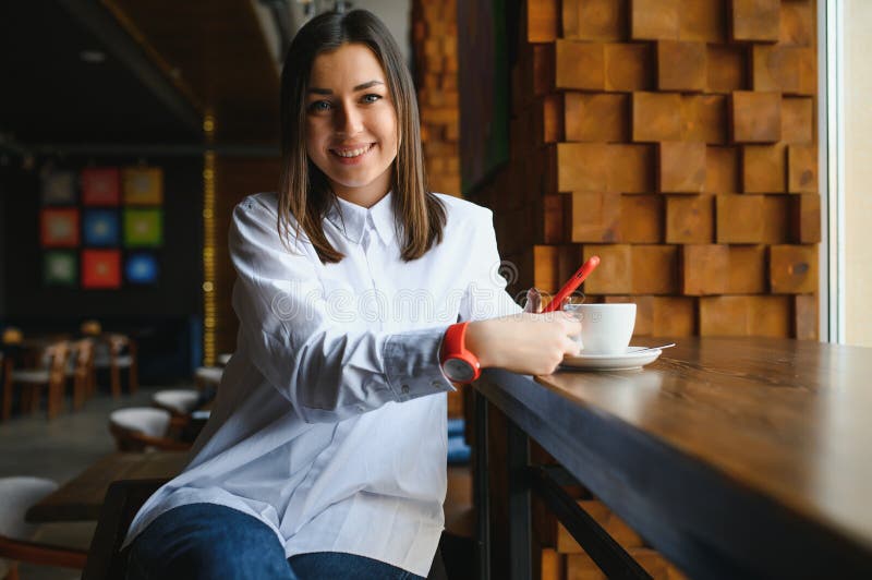 Beautiful Young Woman with a Cup of Tea at a Cafe Stock Photo - Image ...