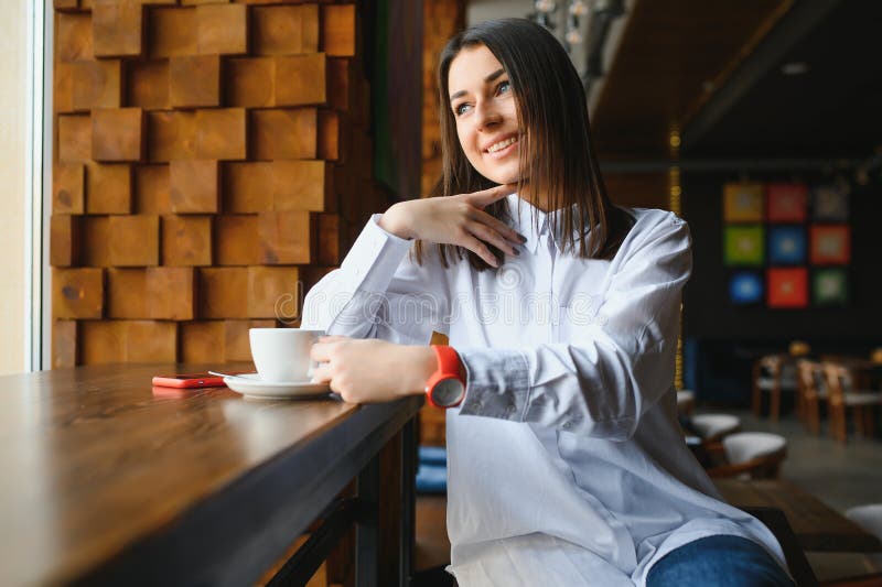 Beautiful Young Woman with a Cup of Tea at a Cafe Stock Photo - Image ...