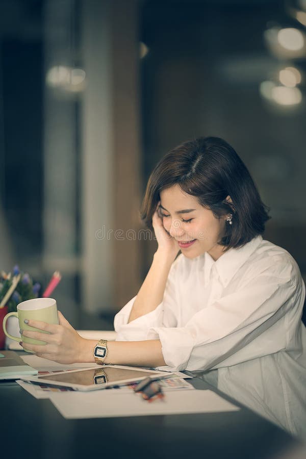 Beautiful Young Woman with a Cup of Tea while Working Stock Image ...