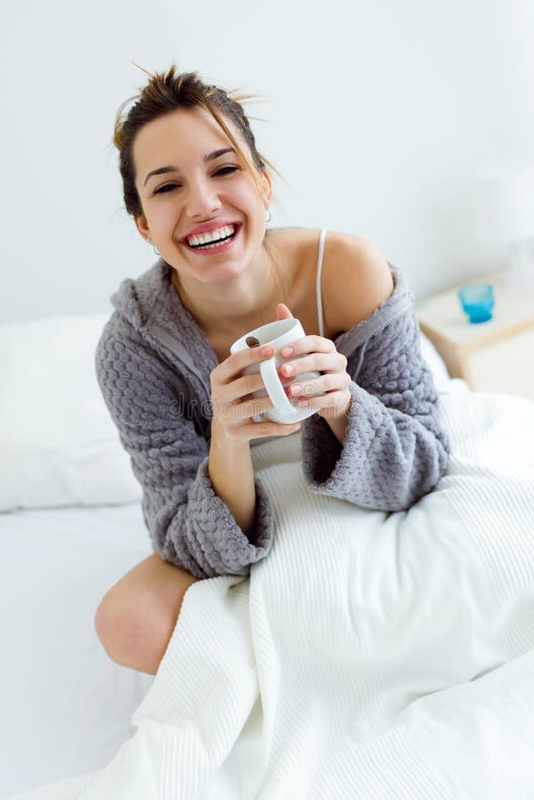 Beautiful Young Woman Drinking Coffee on Bed. Stock Photo - Image of ...