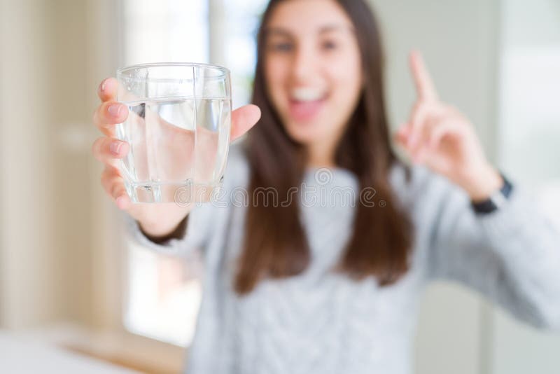 Beautiful Young Woman Drinking A Fresh Glass Of Water Surprised With An