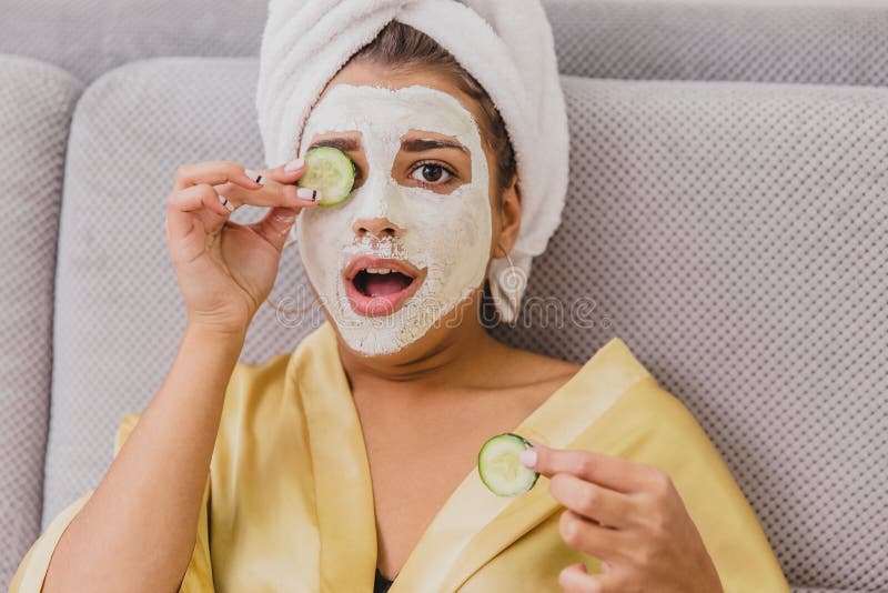 A Beautiful Young Woman Gets A Face Mask In The Spa Center Lying With