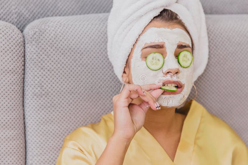 A Beautiful Young Woman Gets A Face Mask In The Spa Center Lying With