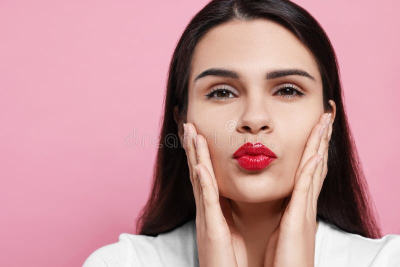 Beautiful Young Woman Giving Kiss on Pink Background, Closeup Stock ... Beautiful Young Woman Giving Kiss on Pink Background, Closeup Stock ...