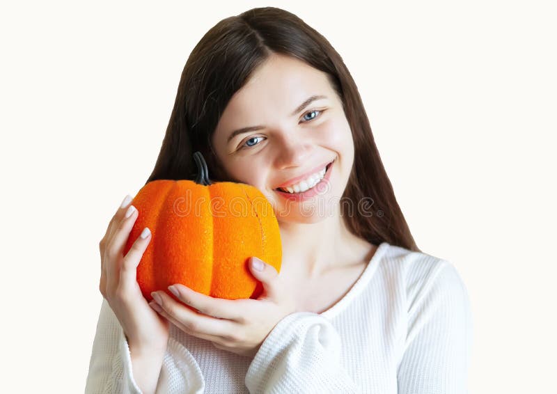 A Beautiful Young Woman Holding a Pumpkin and Smiling at a Halloween ... A Beautiful Young Woman Holding a Pumpkin and Smiling at a Halloween ...