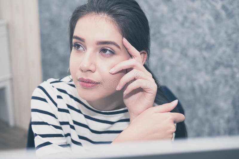 Beautiful Young Woman Looking at a Computer Screen and Thinking Stock ...