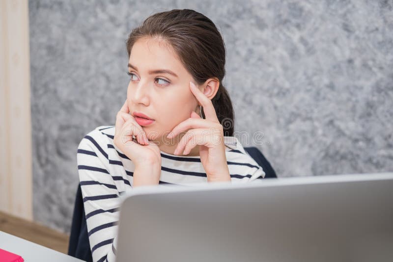 Beautiful Young Woman Looking at a Computer Screen and Thinking Stock ...