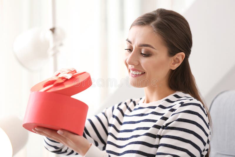 Beautiful Young Woman Opening Gift Box at Home Stock Photo - Image of ...