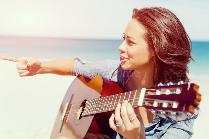 Beautiful Young Woman Playing Guitar on Beach Stock Photo - Image of ...