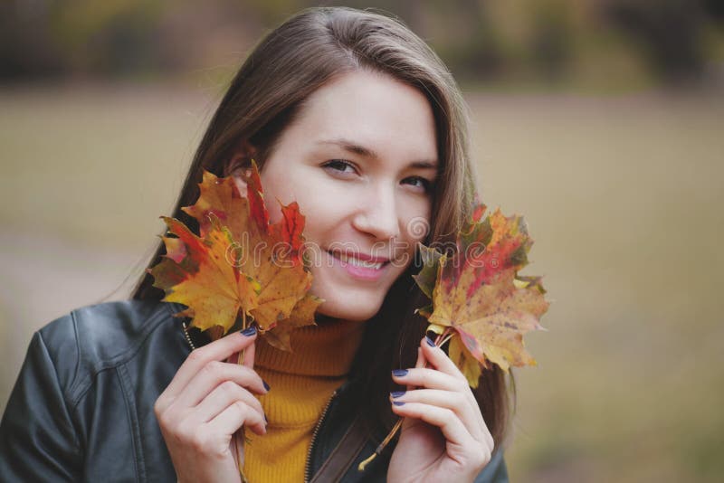 Beautiful Young Woman Portrait Holding Autumn Leaves Outdoors Stock